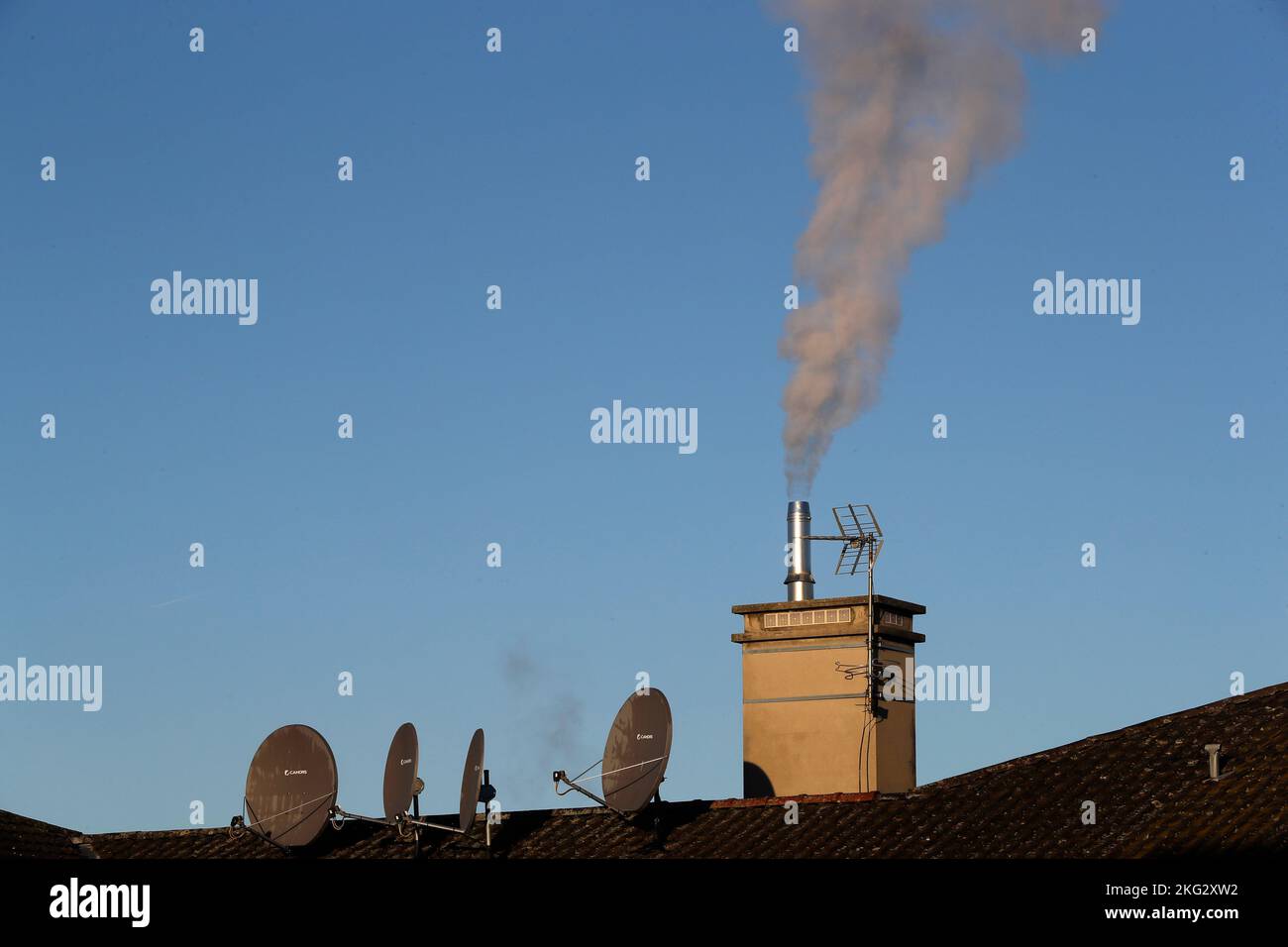 Parabol and smoke coming out of house chimney France Stock Photo - Alamy