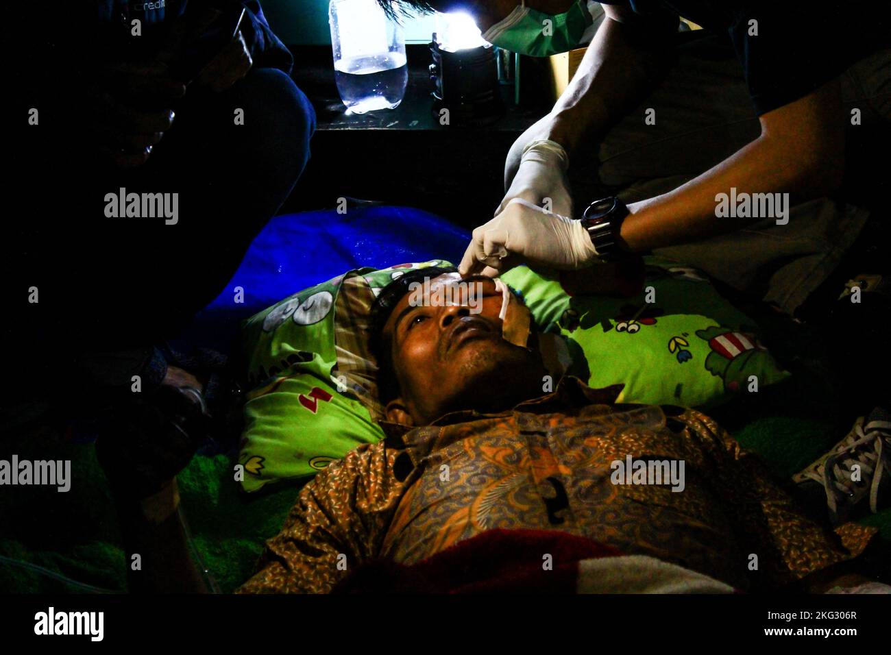 Cianjur, West Java, Indonesia. 21st Nov, 2022. A man receives medical ...