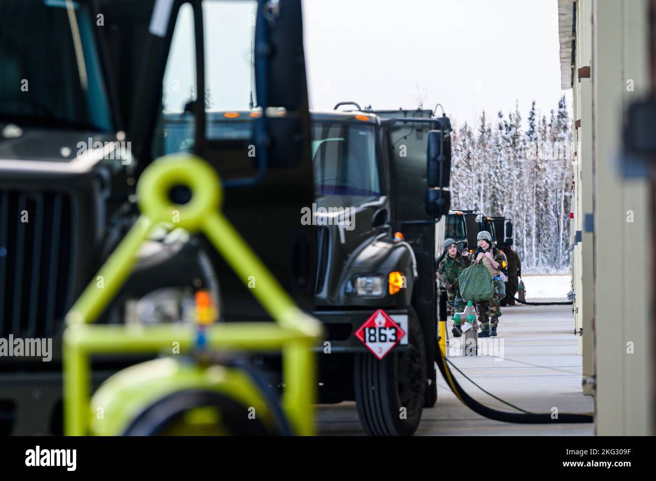 U.S. Airmen assigned to the 355th Aircraft Maintenance Unit walk on the ...