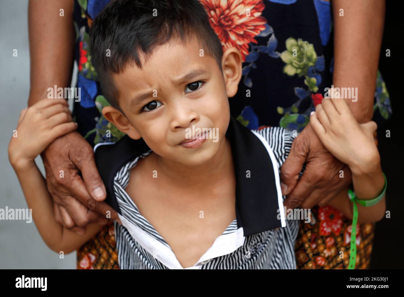 Daily life. Cambodian mother and child living in a poor district ...