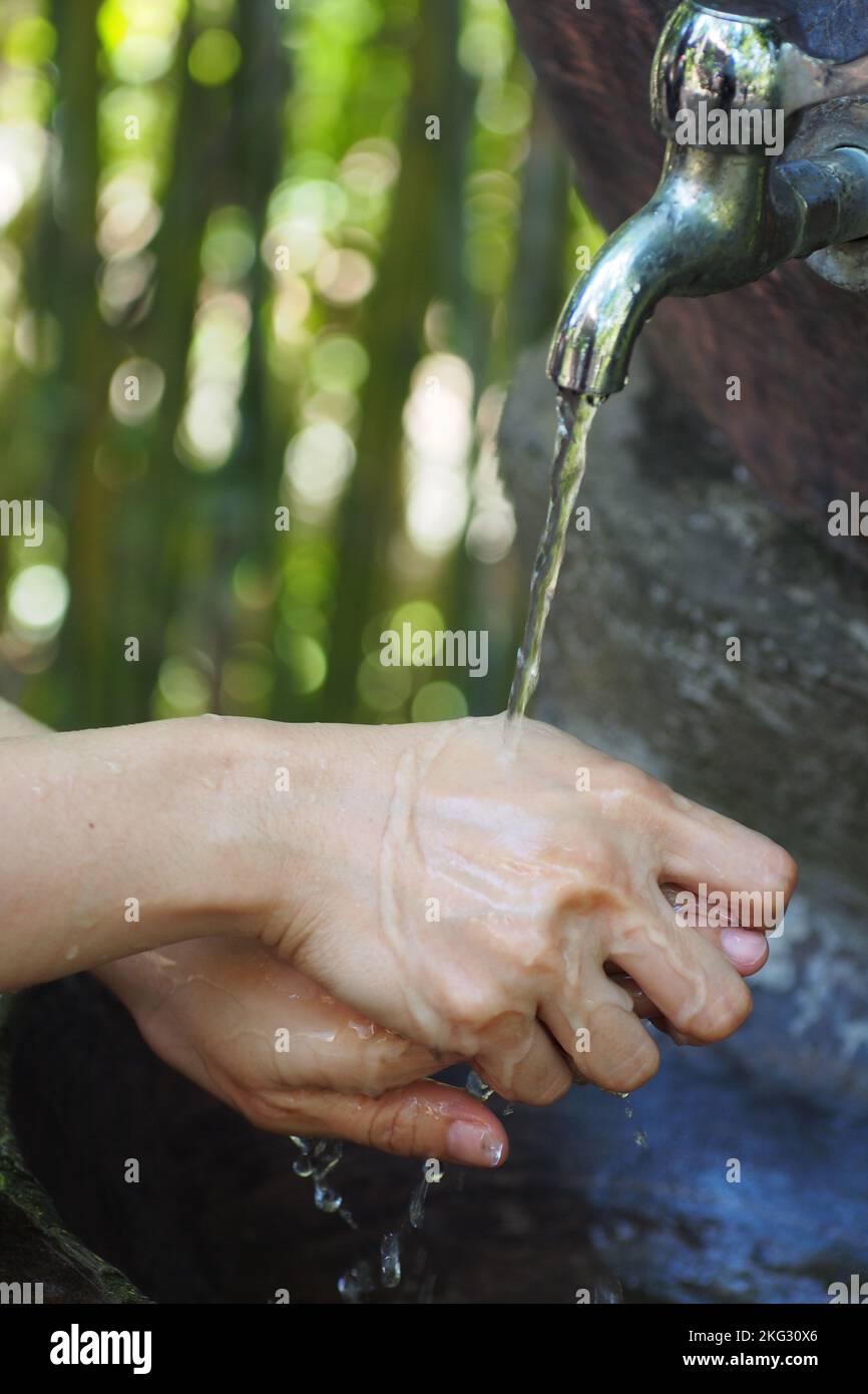 Hand washing and drinking water in a public place in the Philippines ...