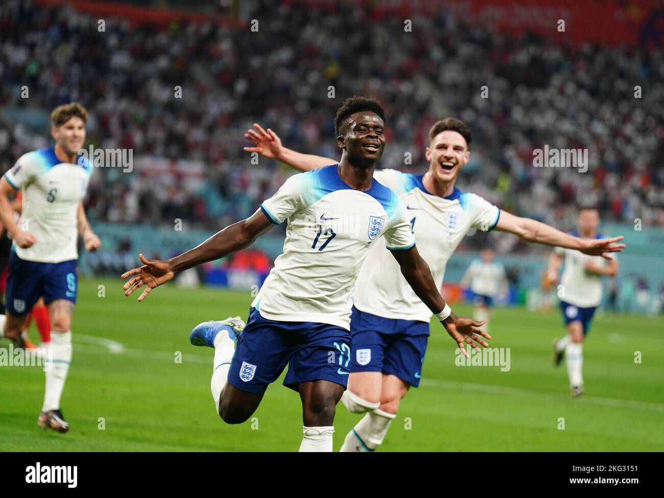 England's Bukayo Saka (left) celebrates scoring their side's second ...