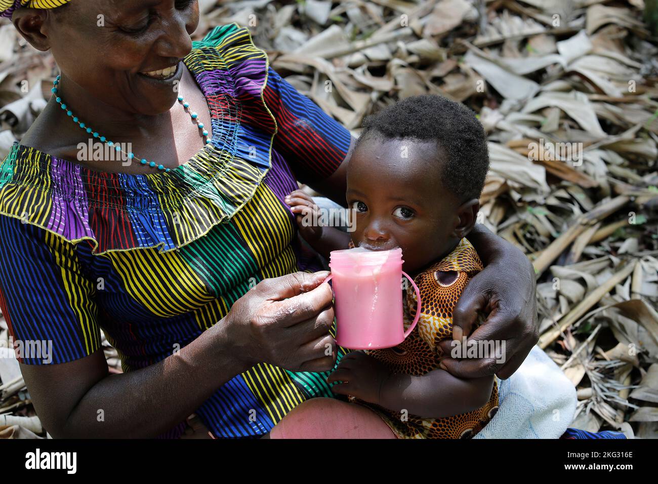 Kopakama coffee grower's cooperative, Rutsiro, Rwanda. Mother hfeeding ...