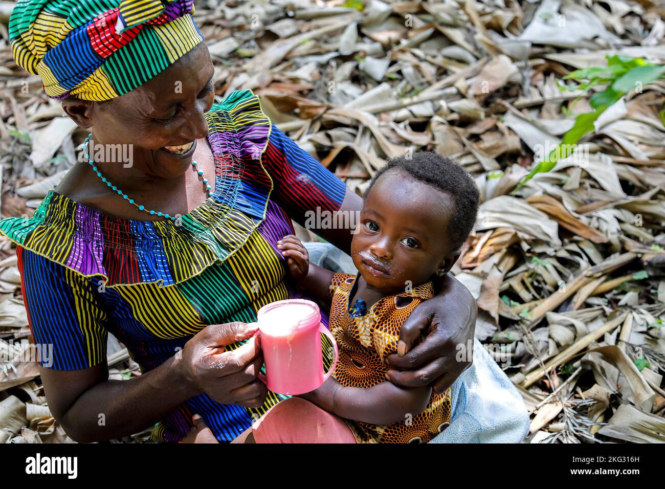 Kopakama coffee grower's cooperative, Rutsiro, Rwanda. Mother hfeeding ...