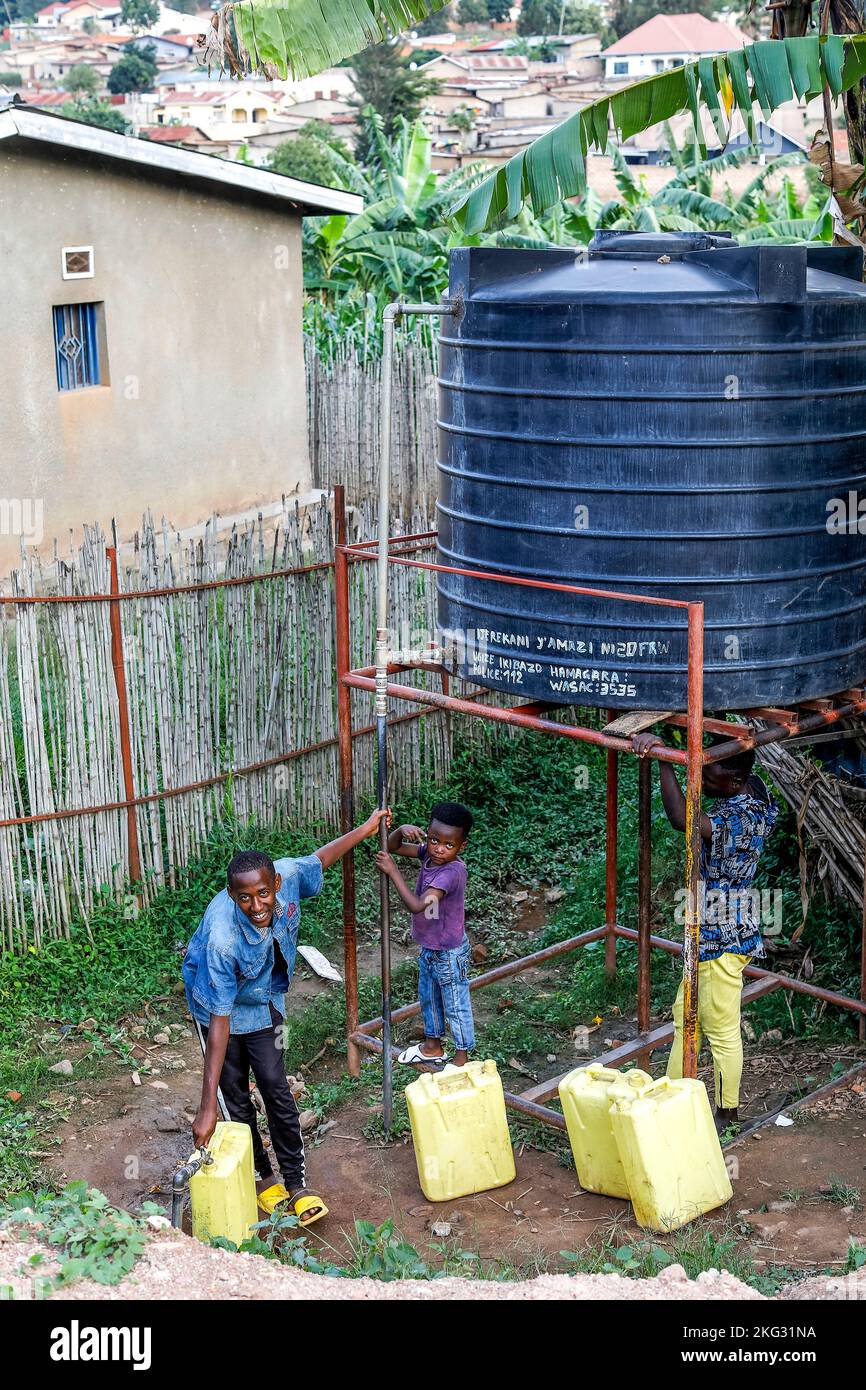 Father and children on water chore in Kigali, Rwanda Stock Photo - Alamy
