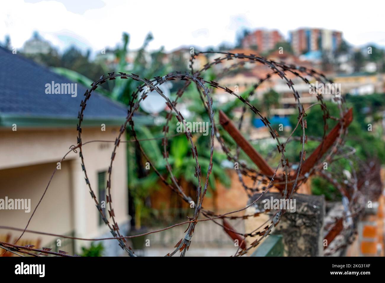 Barbed wire on a house wall in Kigali, Rwanda Stock Photo - Alamy