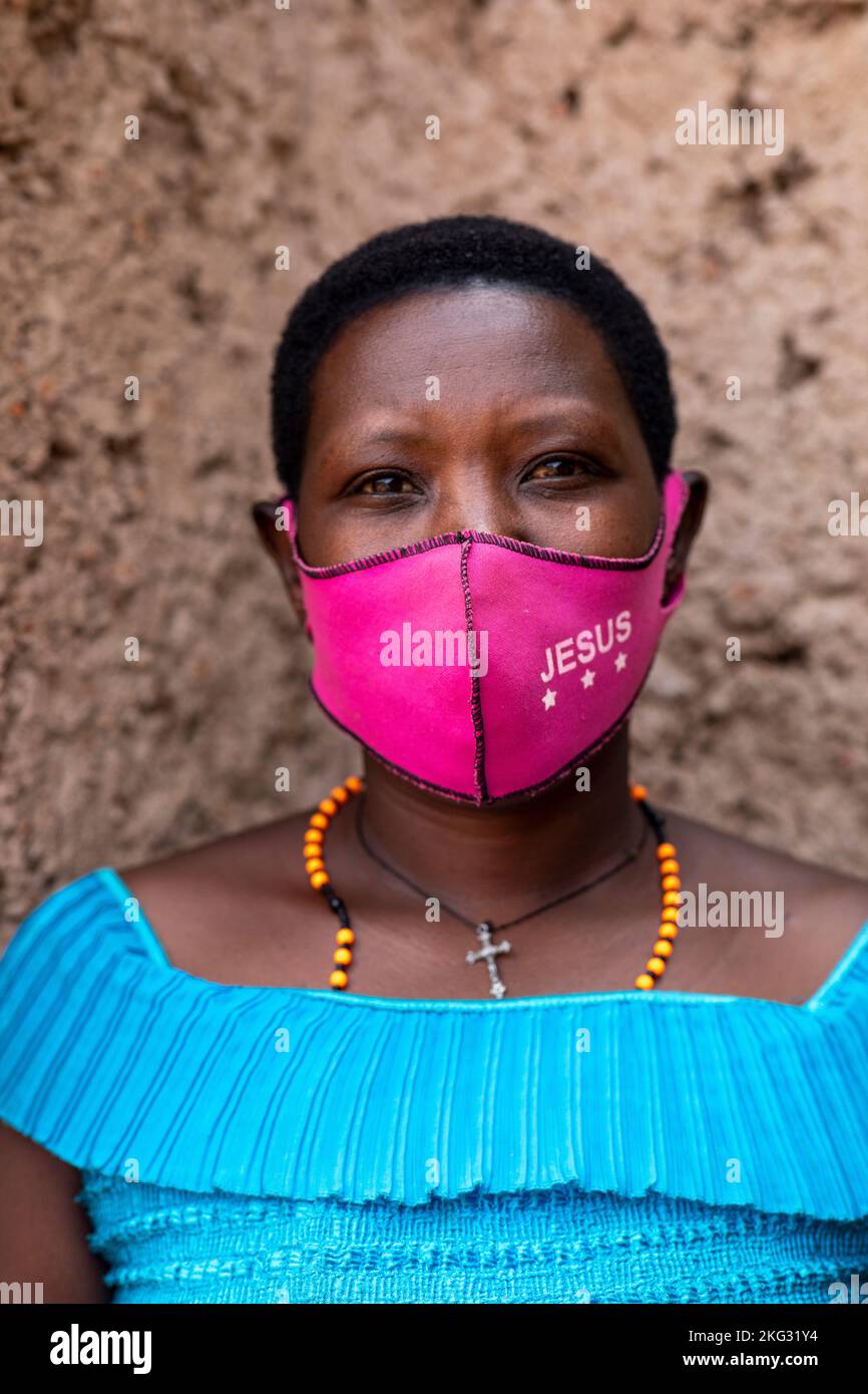 Christian Rwandan wearing a face mask in a village near Gicumbi ...