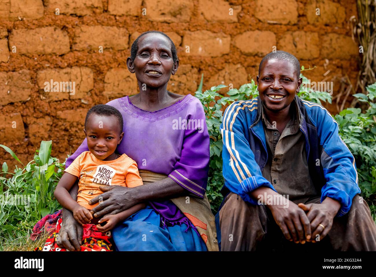 Family sitting in a village in northern Rwanda Stock Photo - Alamy