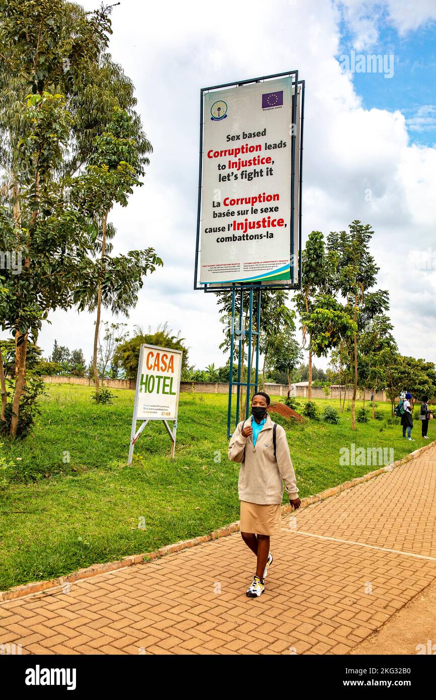 Student walking past an anti-corruption sign in Huye, southern Rwanda ...
