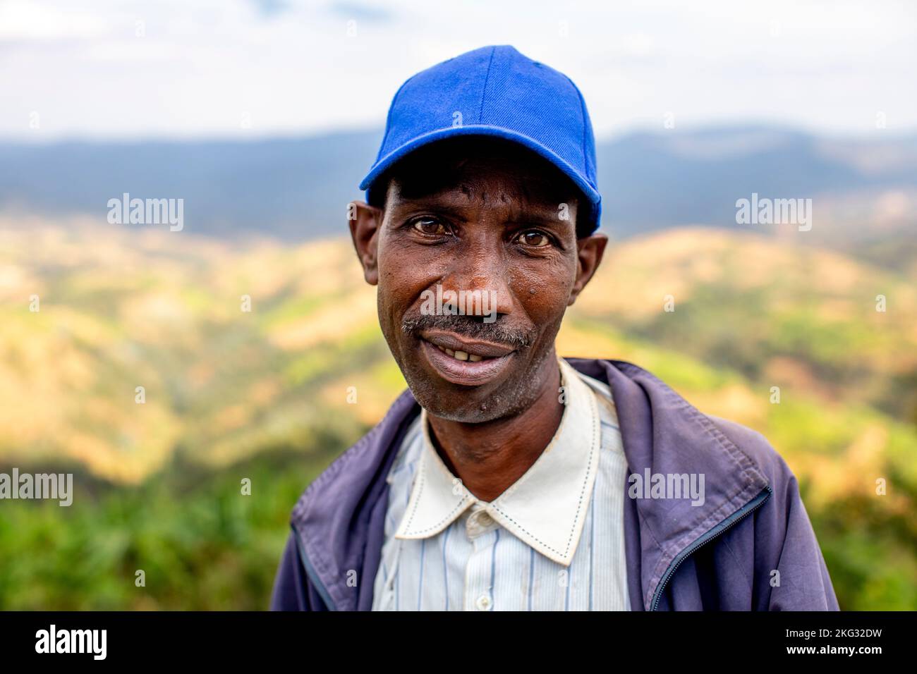 Man standing on a roadside in western Rwanda Stock Photo - Alamy