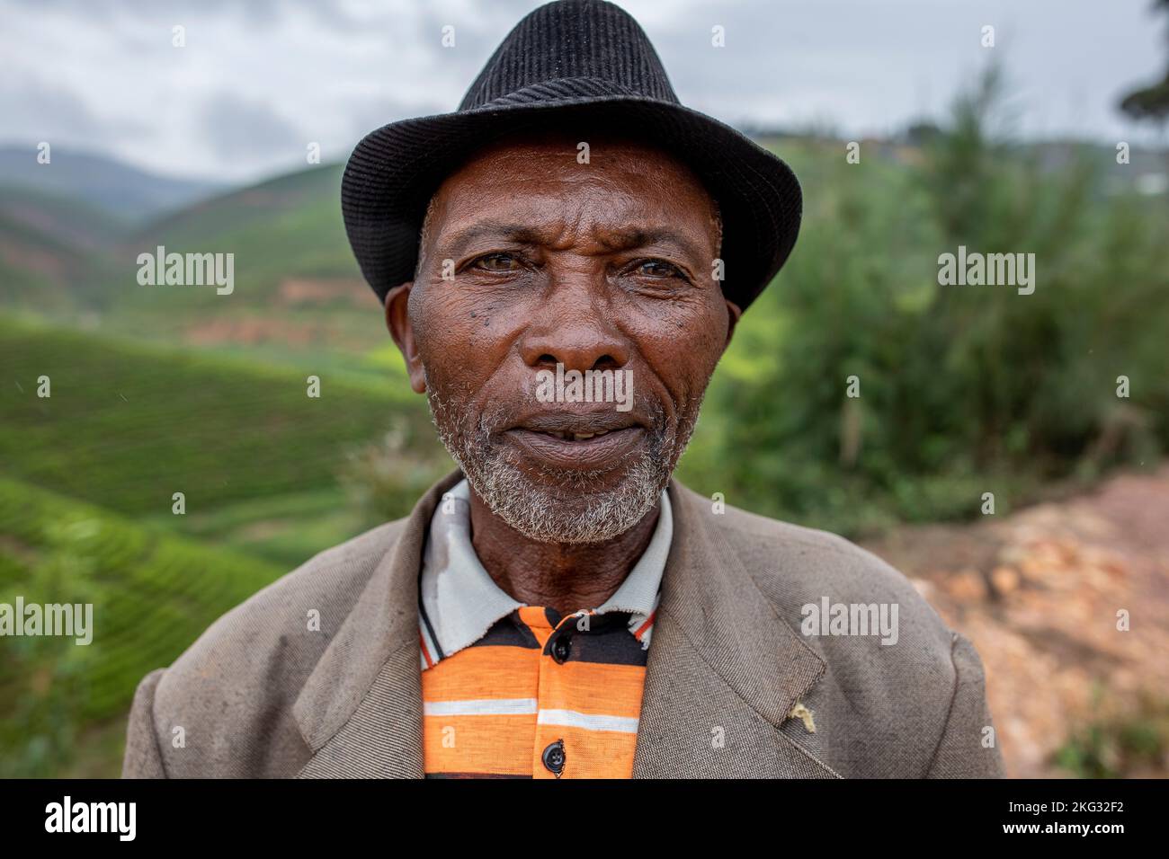 Elderly man standing in western Rwanda Stock Photo - Alamy