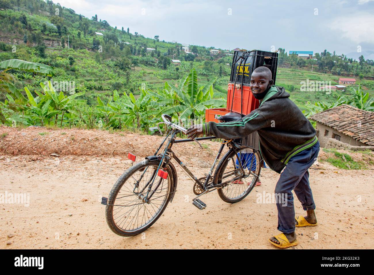 Man pushing a bike loaded with crates in western Rwanda Stock Photo - Alamy