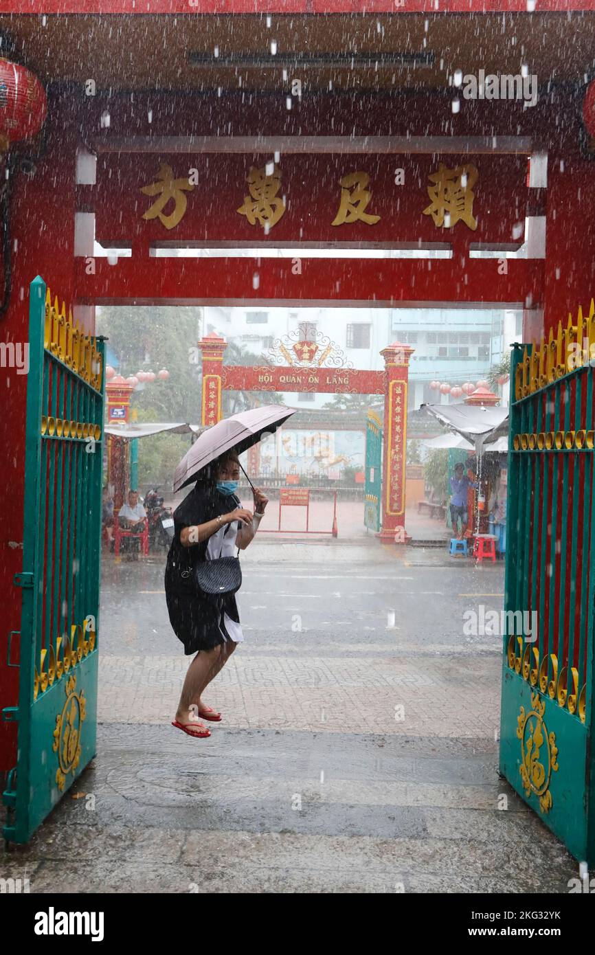Quan Am buddhist Temple. Heavy rain during the rainy season. Woman with ...