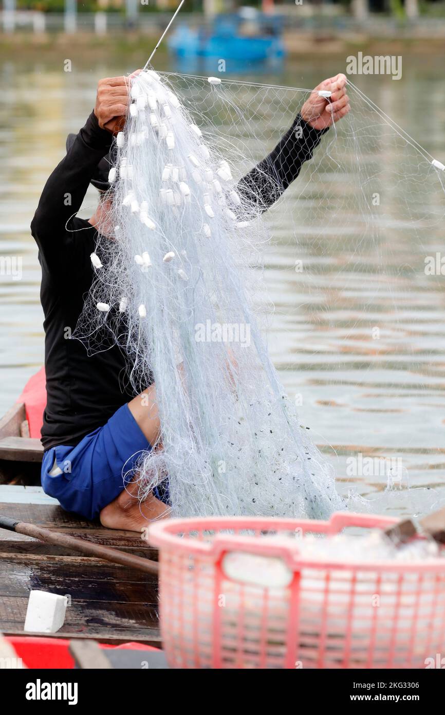 Fisherman with net on boat. Fishing in river. Hoi An. Vietnam Stock ...