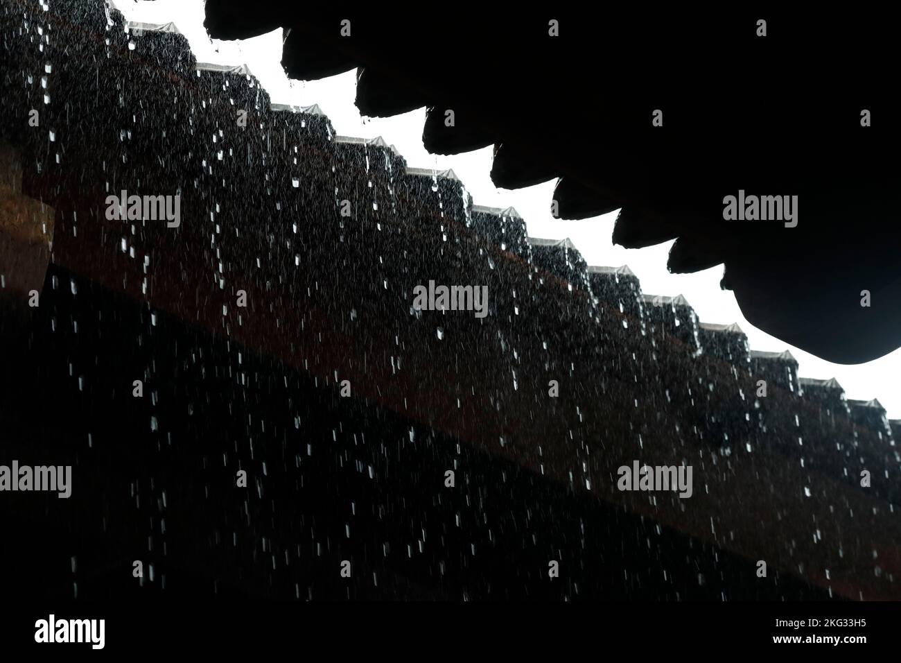 Rain drops falling over roof during monsoon. Rainy day and rainy season ...