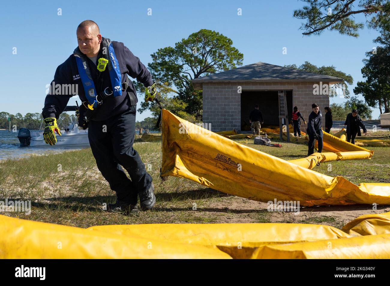 Members of the 96th Civil Engineer Group drag an oil containment device ...