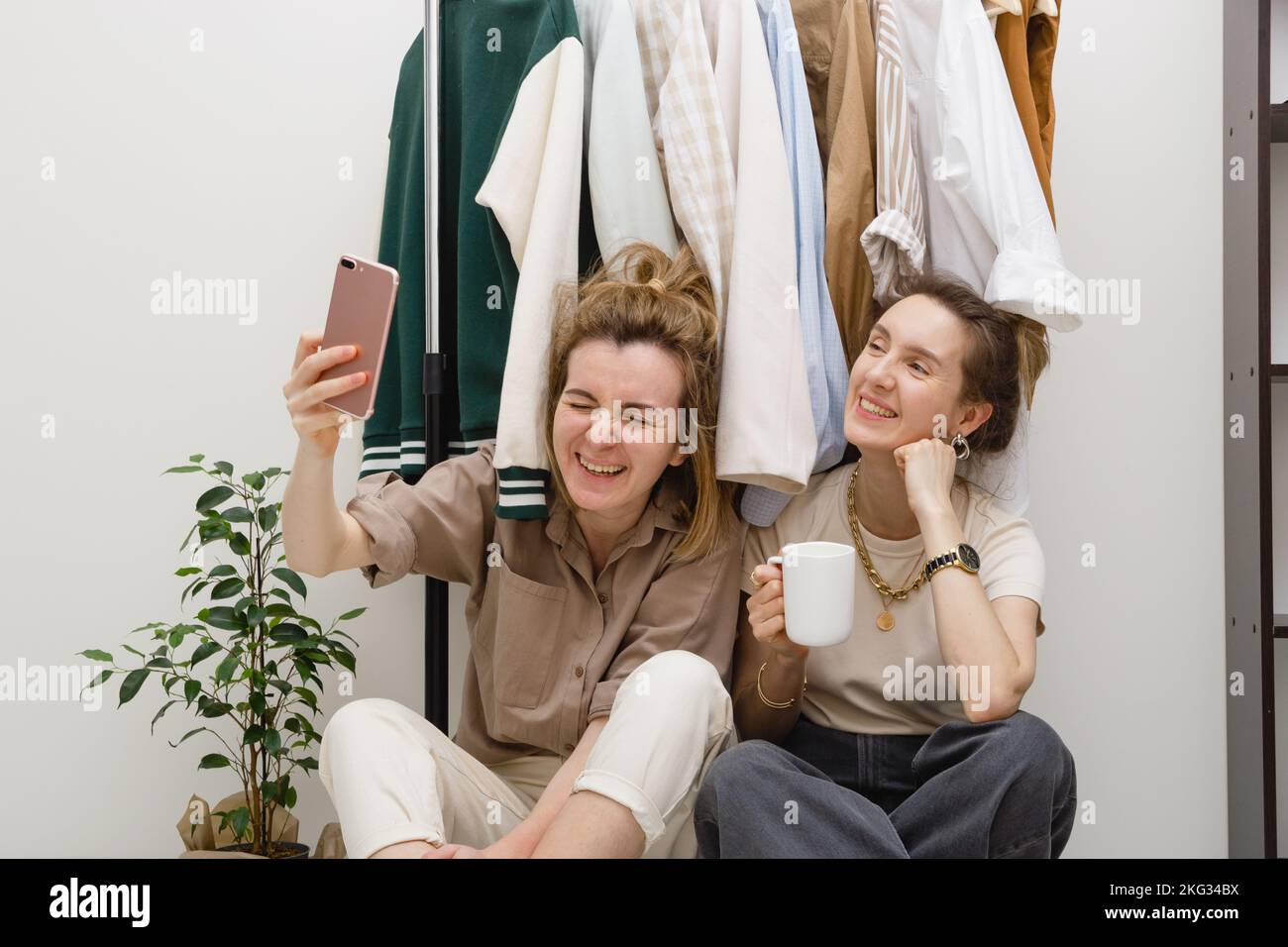 Wardrobe organization concept - two female friends making selfie near ...