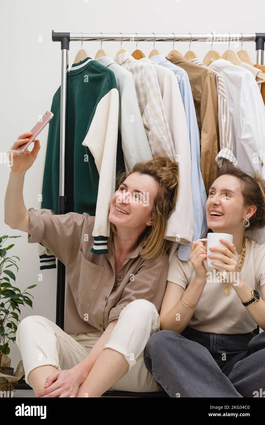 Wardrobe organization concept - two female friends making selfie near ...