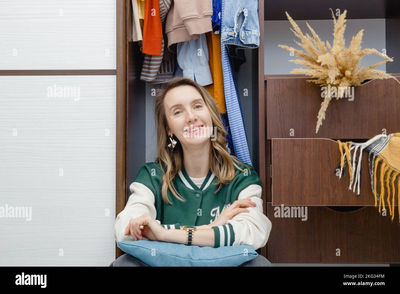 Woman sitting in closet. Wardrobe organization Stock Photo - Alamy