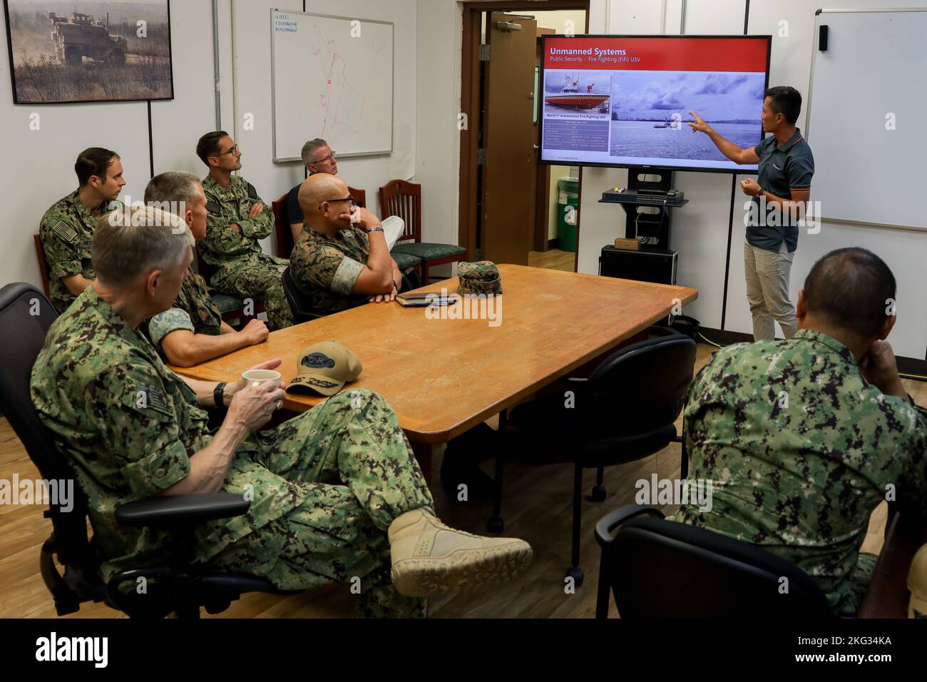 NG Chee Wee, ST Engineering, delivers a capabilities brief to Rear Adm ...
