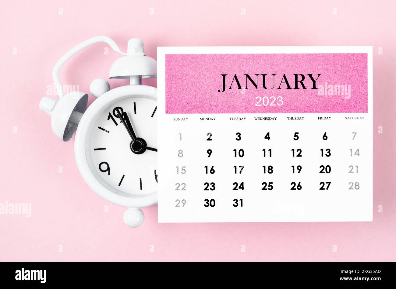 January 2023 Monthly calendar year with alarm clock on pink colour ...