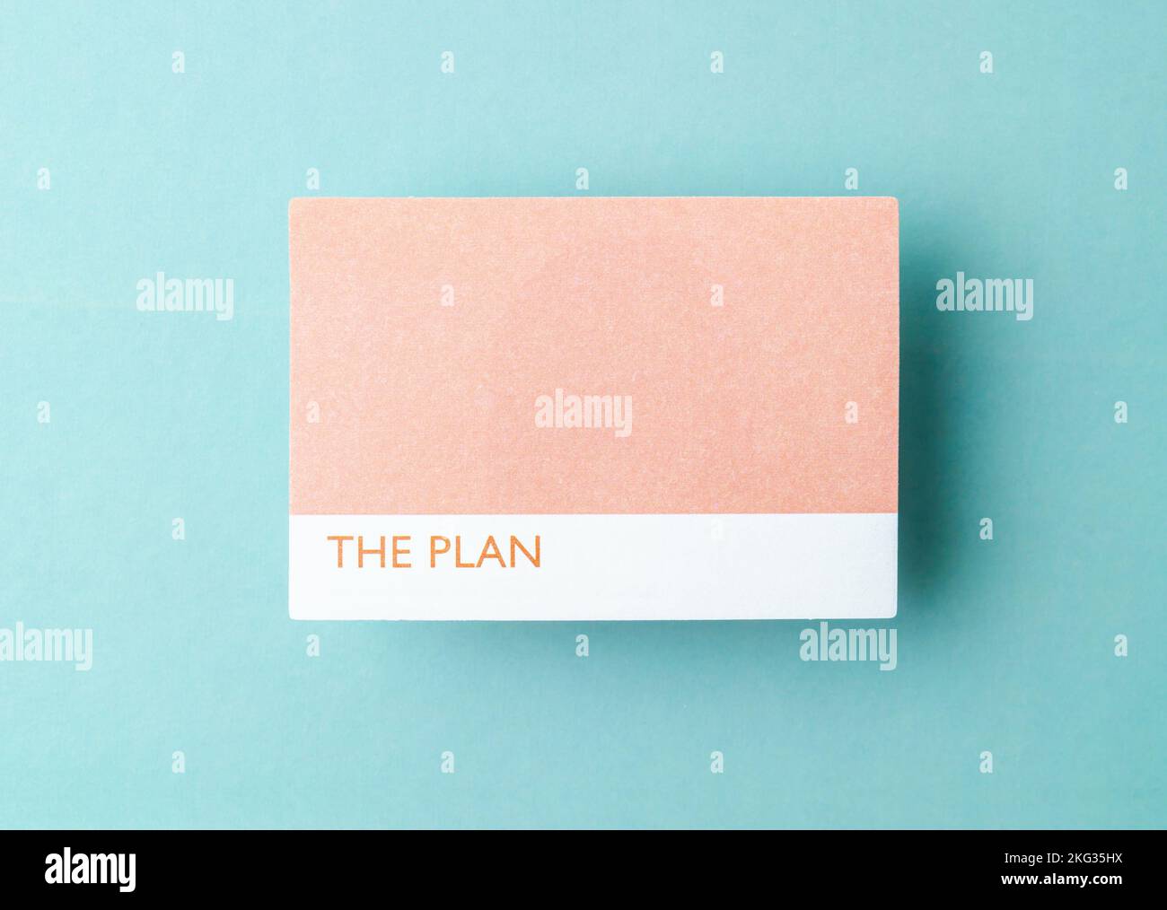 Blank adhesive sticky note on a green cardboard background with copy ...