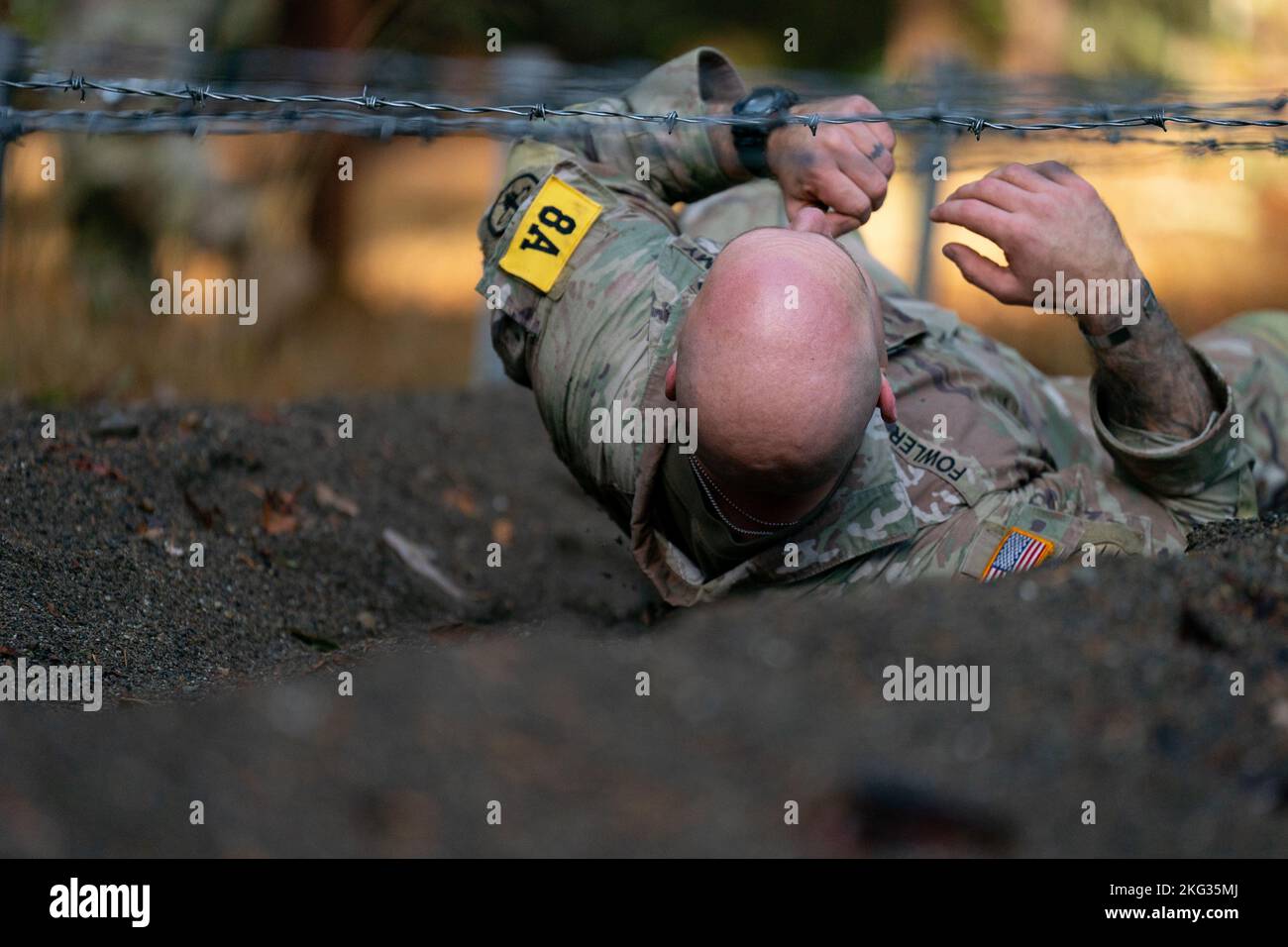 Sgt. 1st Class Cory Fowler from Madigan Army Medical Center, crawls ...