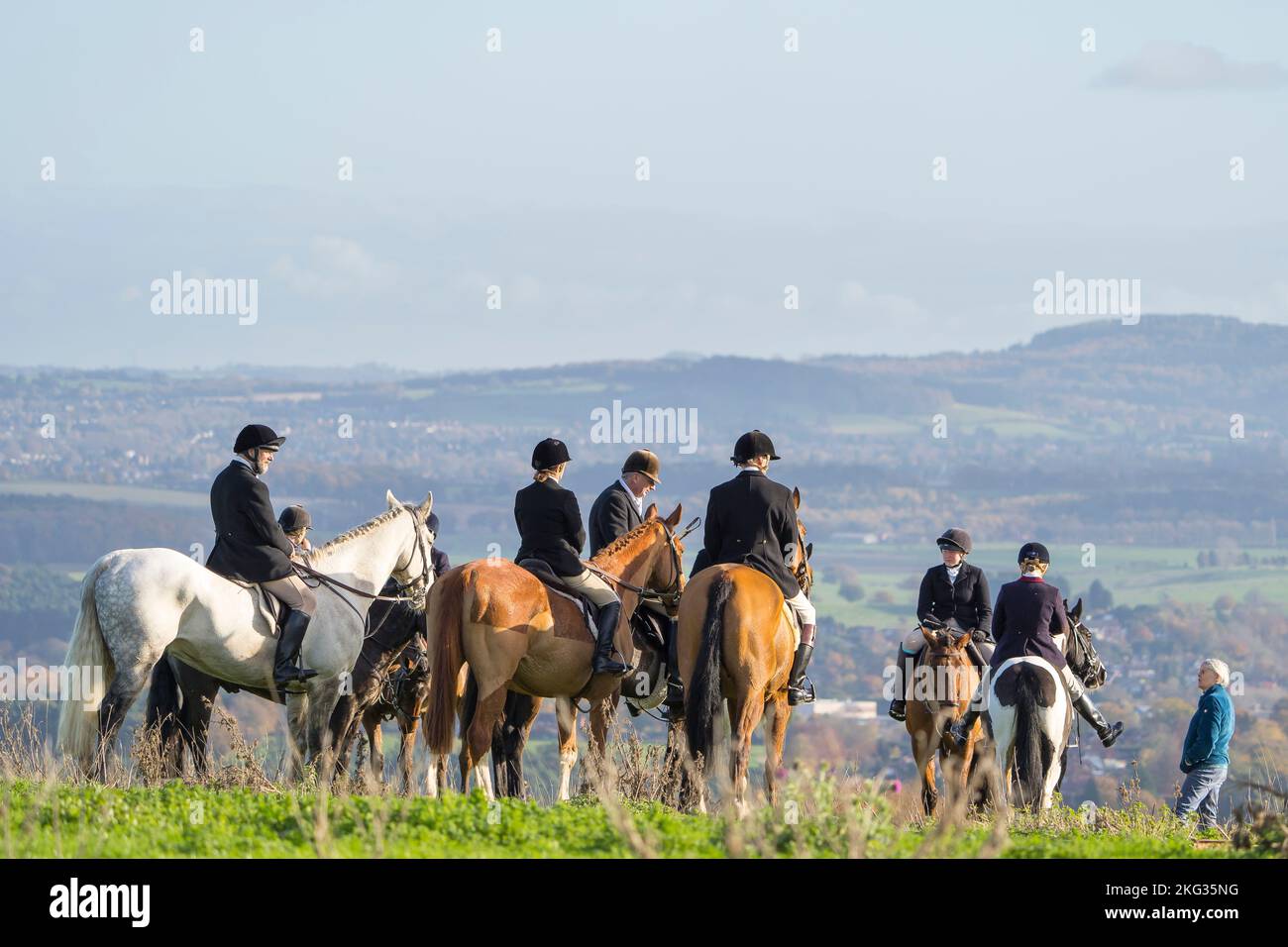 Rear view of huntsmen on horses in the middle of a fox hunting ride in ...