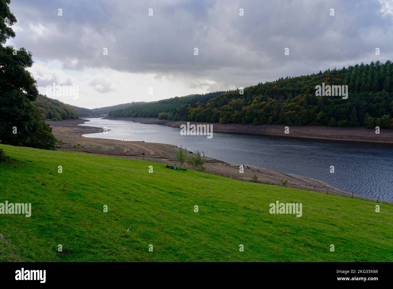 Dark rain clouds gather over the receding waters of the Ladybower ...
