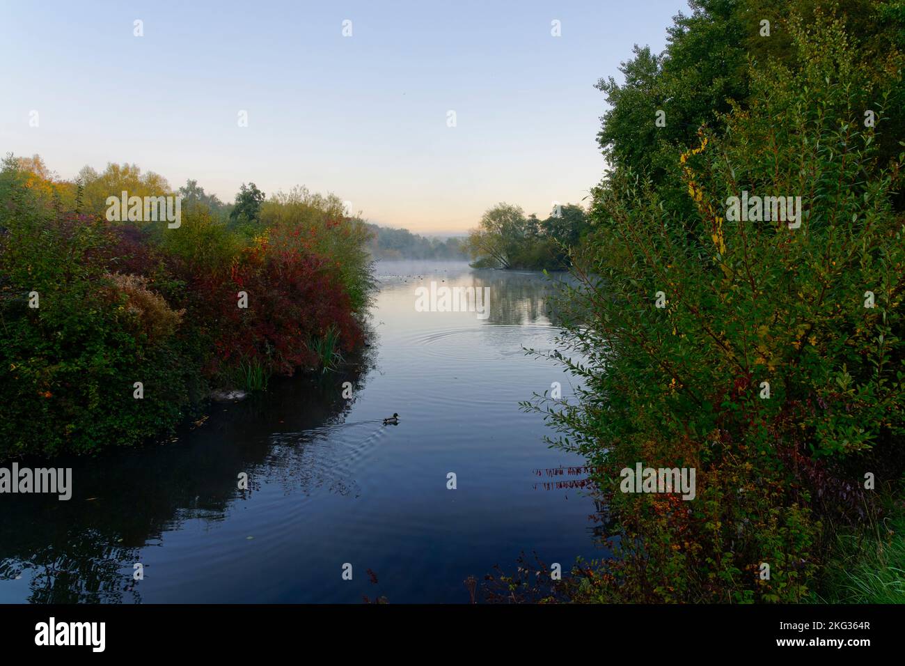 Mist rises from Mill Lakes on a bright but cold autumn morning Stock ...