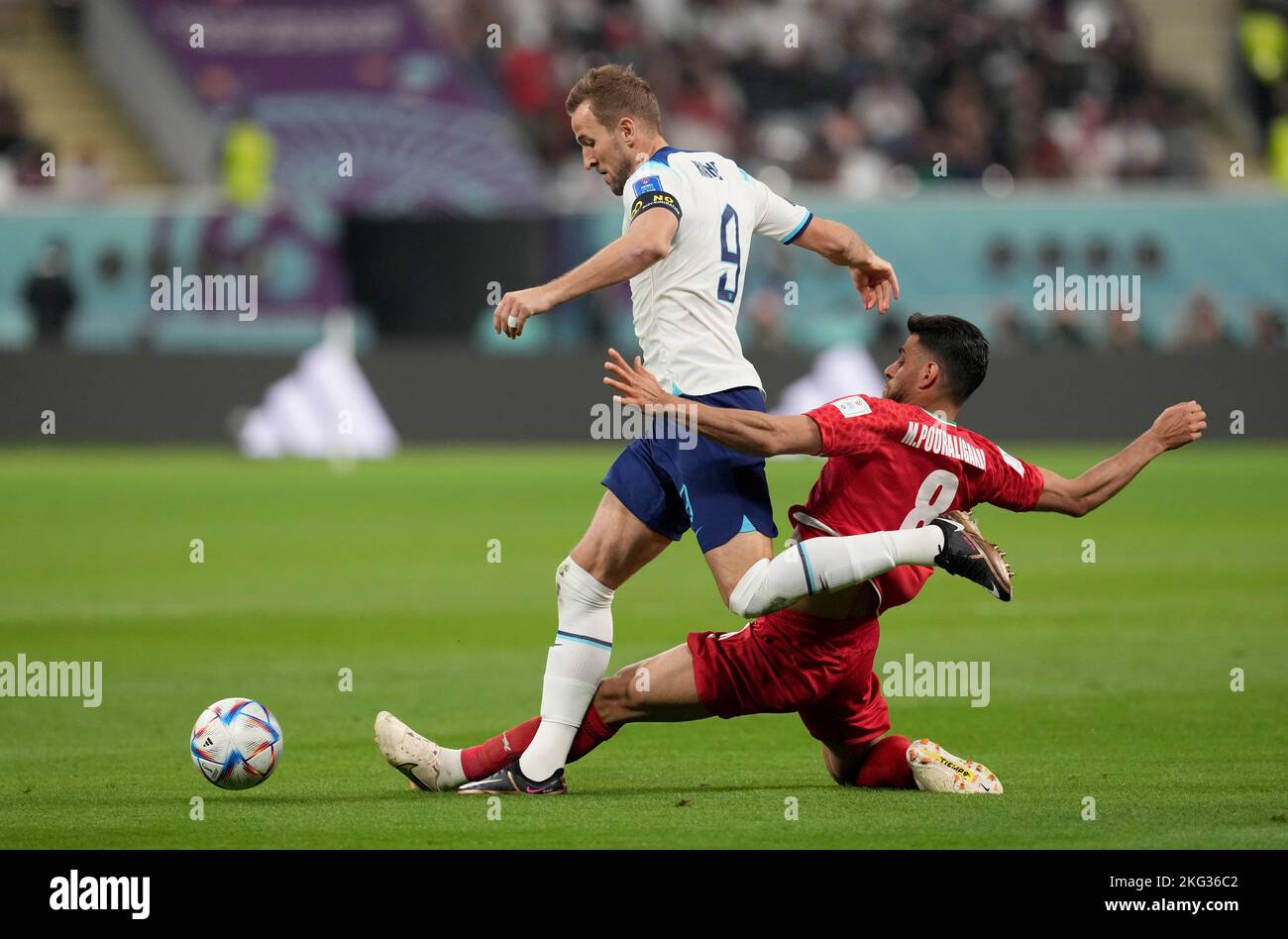 England's Harry Kane (left) is fouled by Iran's Morteza Pouraliganji ...