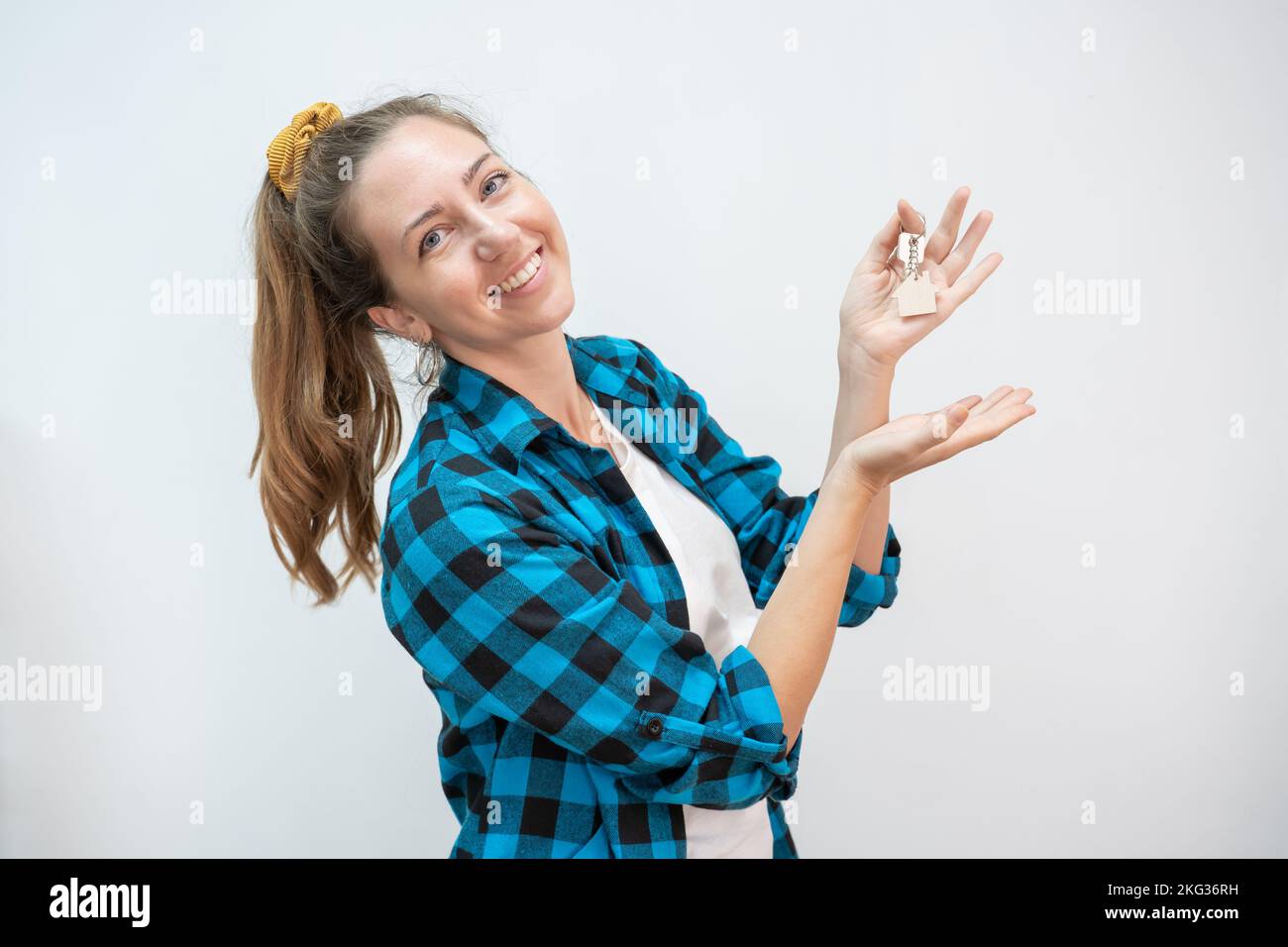 Excited young lady tenant buyer moving to new home with keys in hand ...