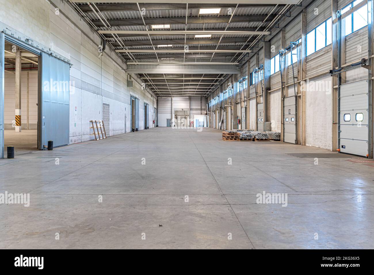 Low angle shot of empty storehouse covered under solid steel roof and ...