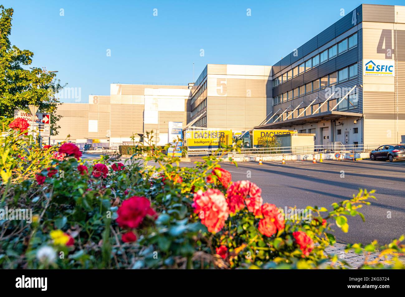 Perspective shot of industrial buildings featuring blooming flowers in ...