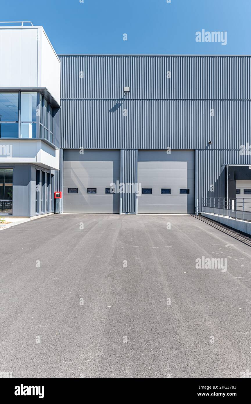 A portrait shot of warehouse building with roller shutter doors Stock ...