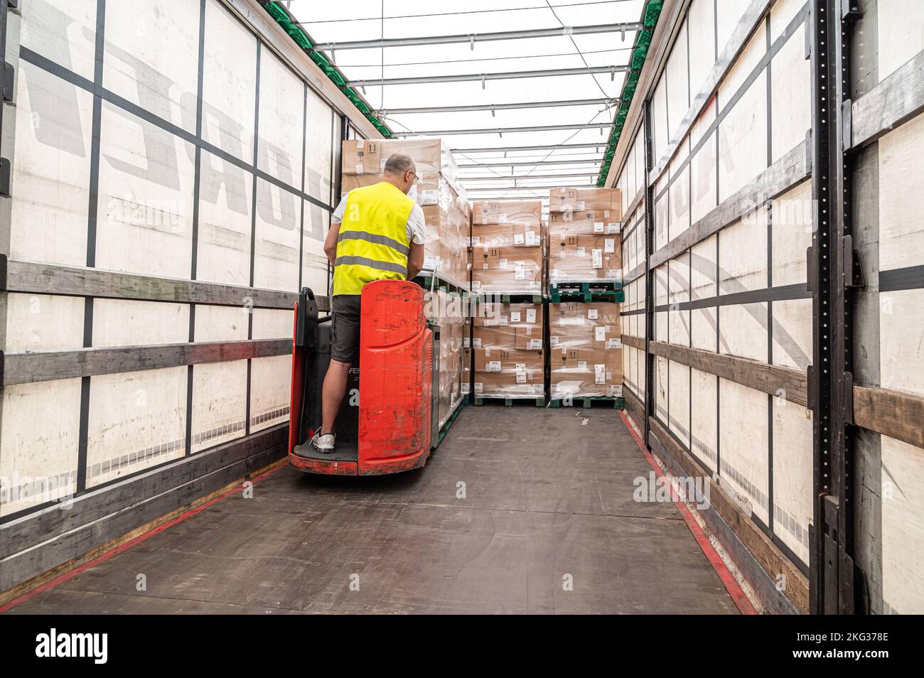 closeup shot of warehouse worker in uniform delivery and loading pallet ...