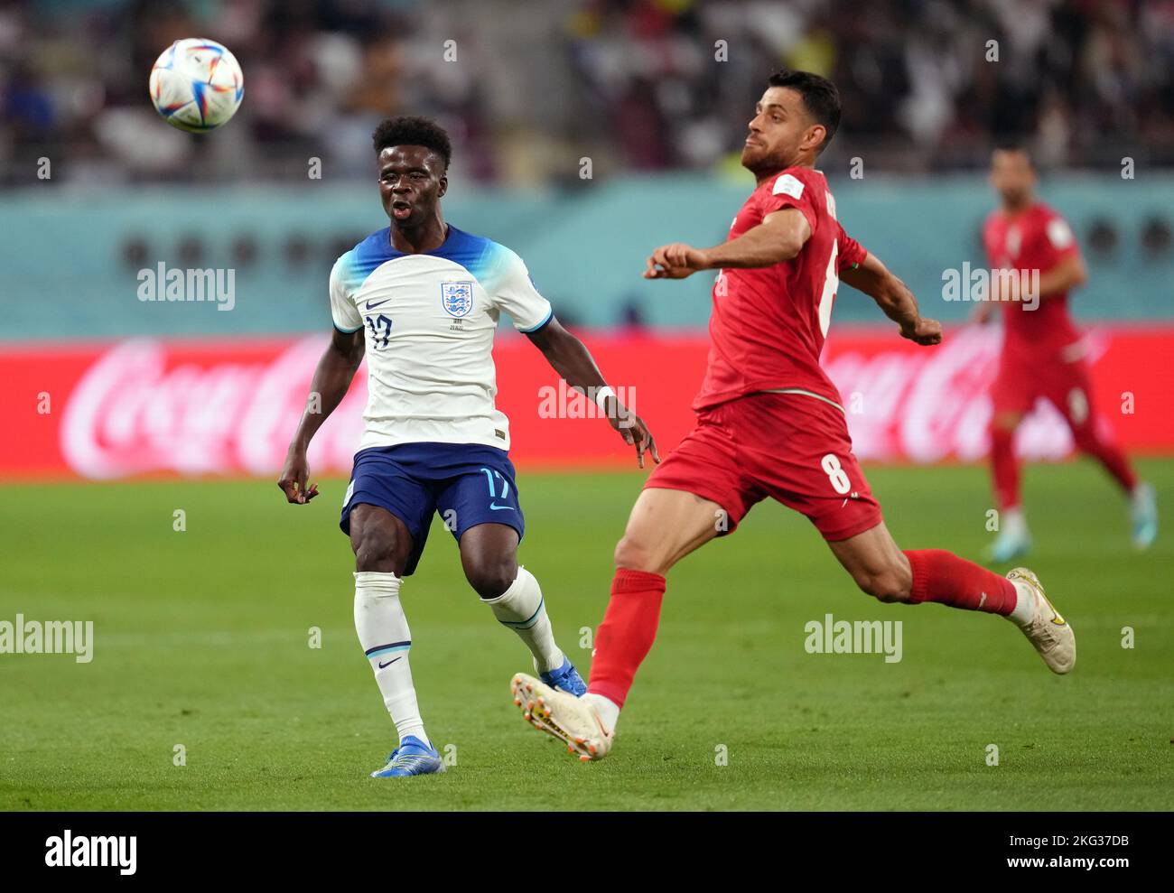 England's Bukayo Saka (left) and Iran's Morteza Pouraliganji battle for ...