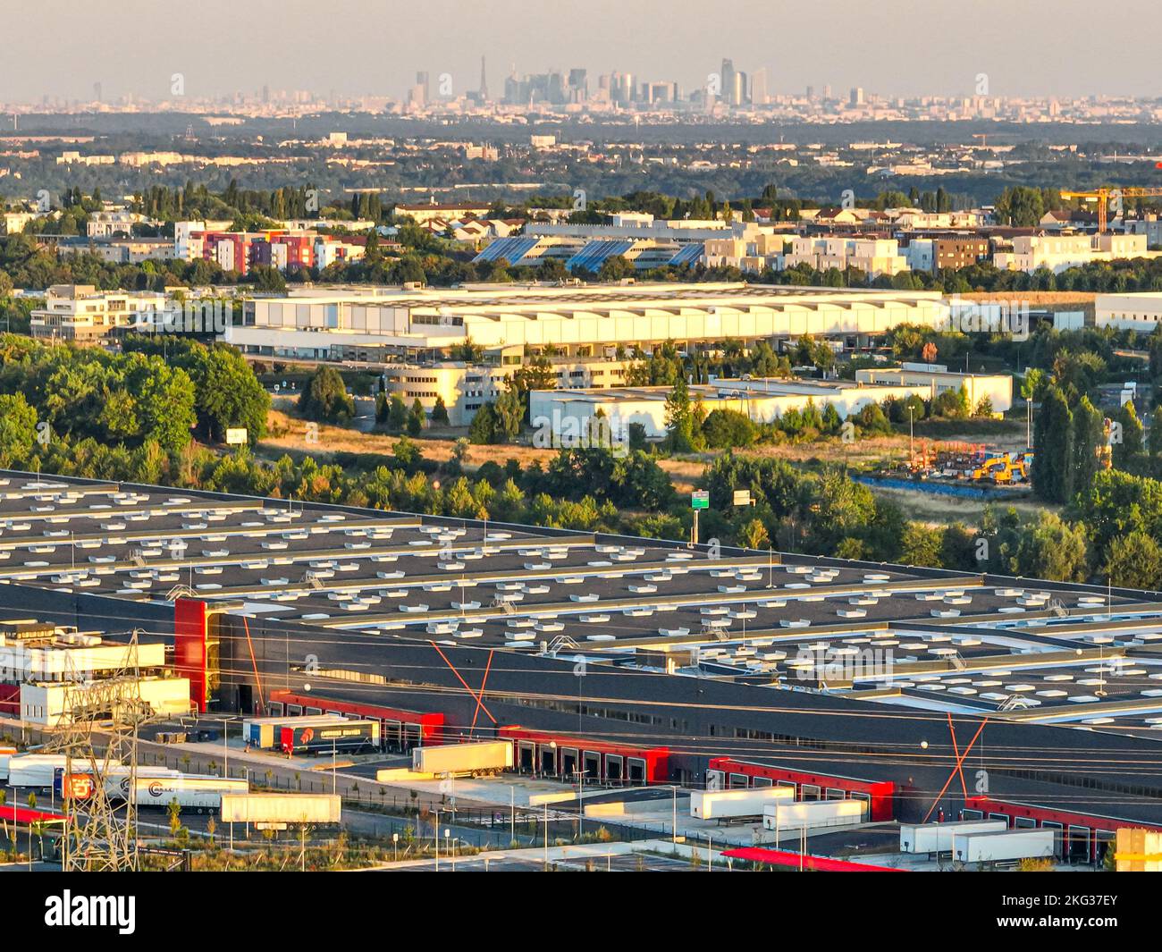 Drone shot of warehouse building featuring trucks parked in the loading ...
