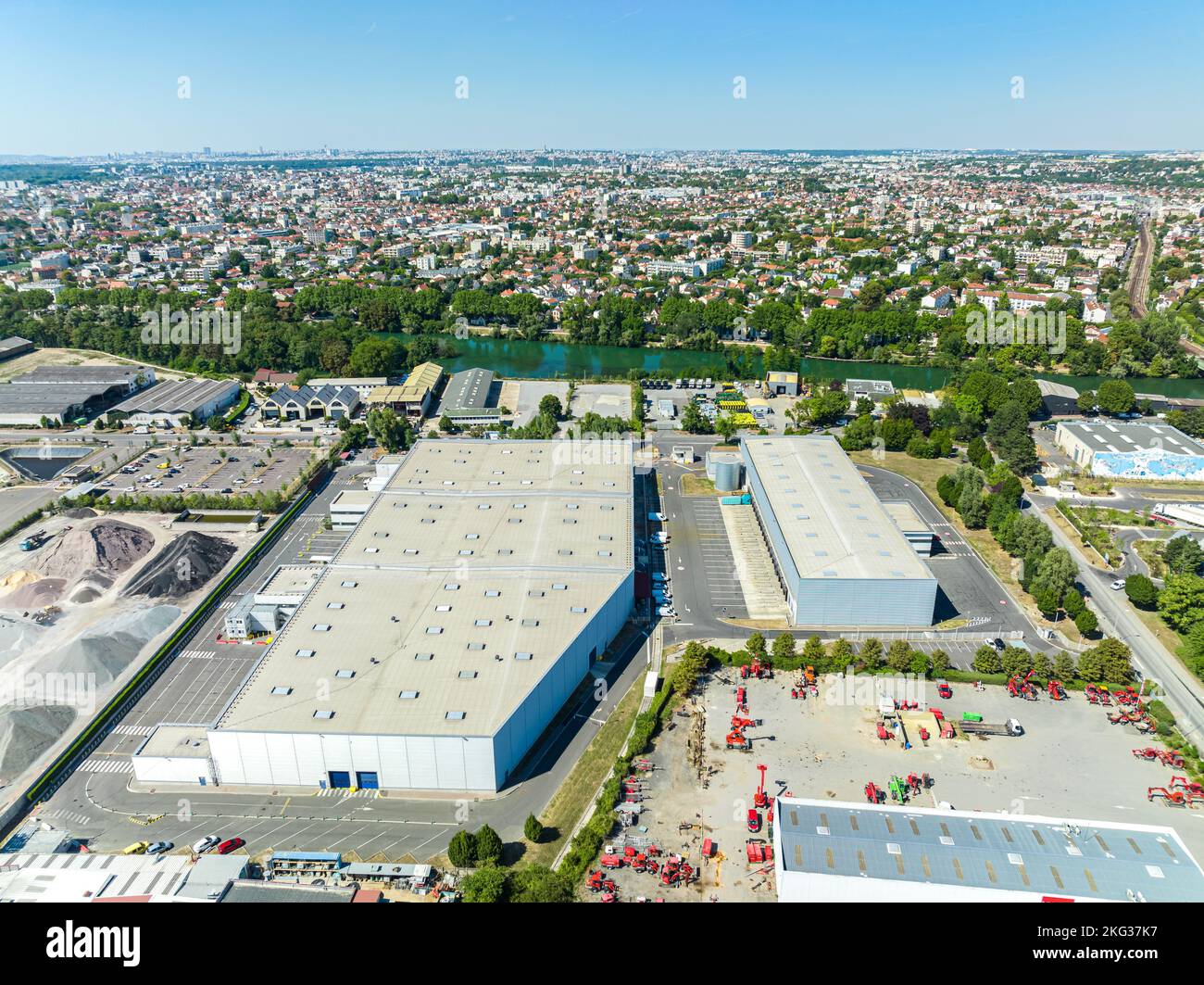 Drone shot of warehouse from above featuring greenery and many ...