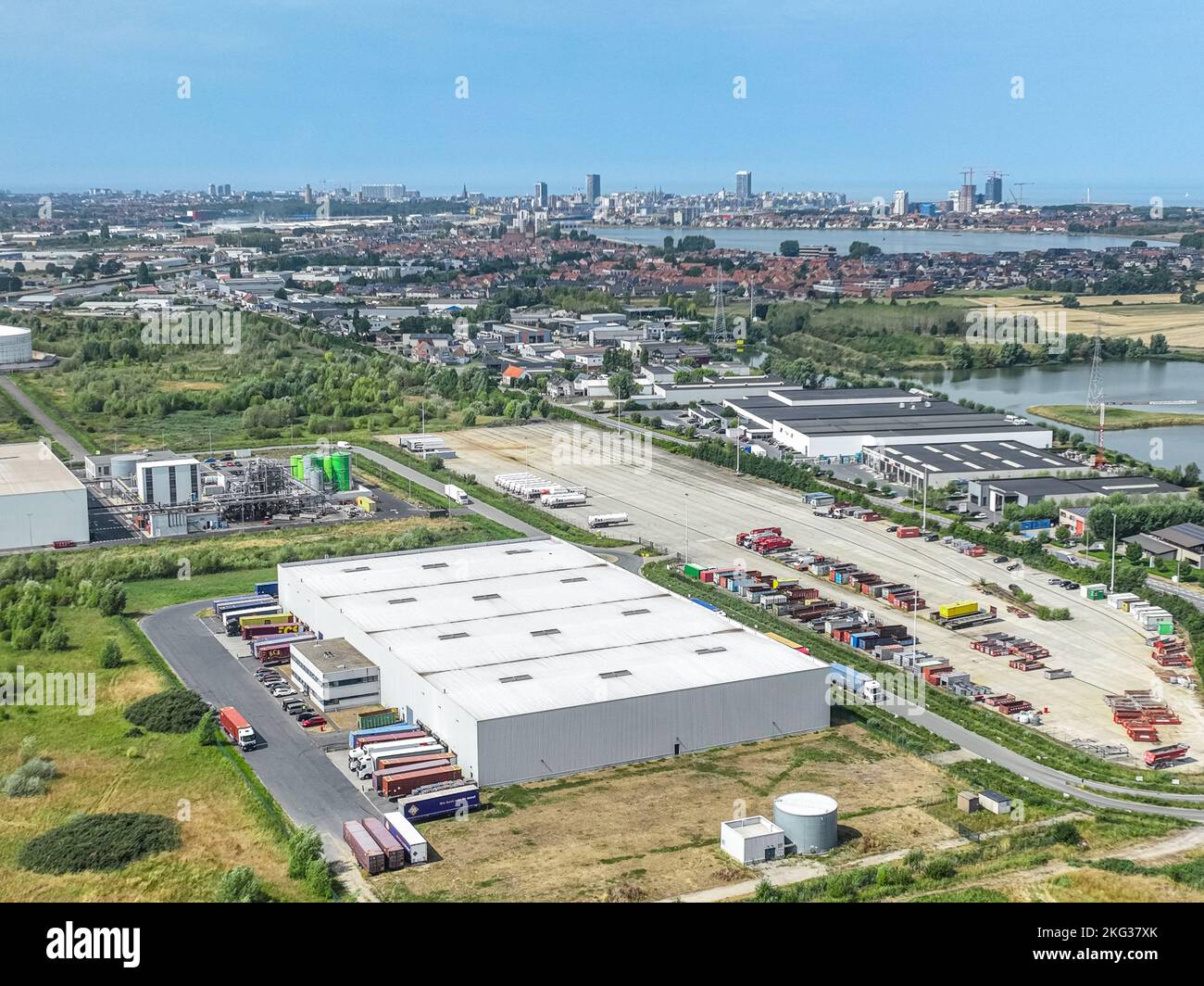 Aerial shot of industrial zone surrounded by greenery any trucks parked ...