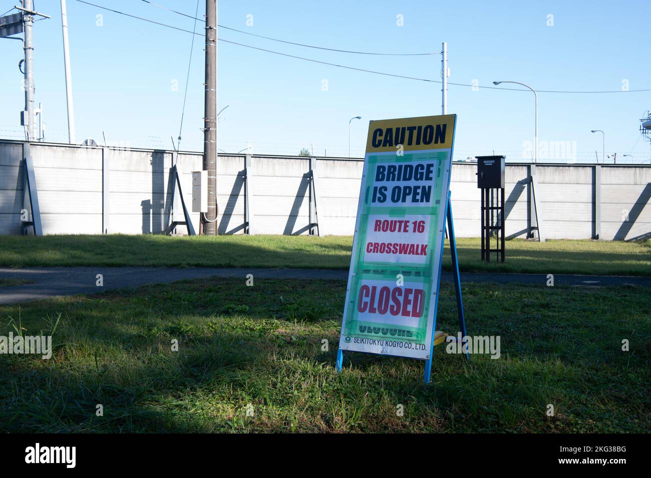 A sign is placed to notify people of the pedestrian bridge reopening at ...