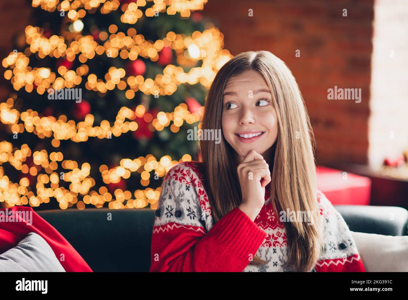 Portrait of minded creative positive girl sit sofa hand touch chin ...