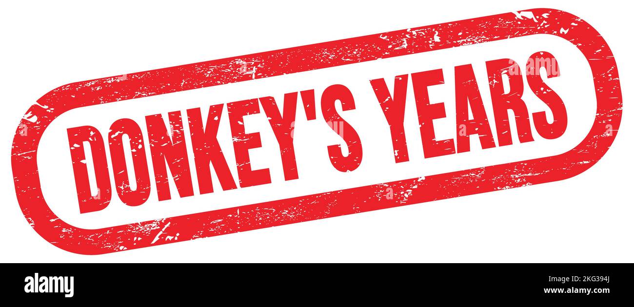 DONKEY'S YEARS, text on red rectangle stamp sign Stock Photo - Alamy