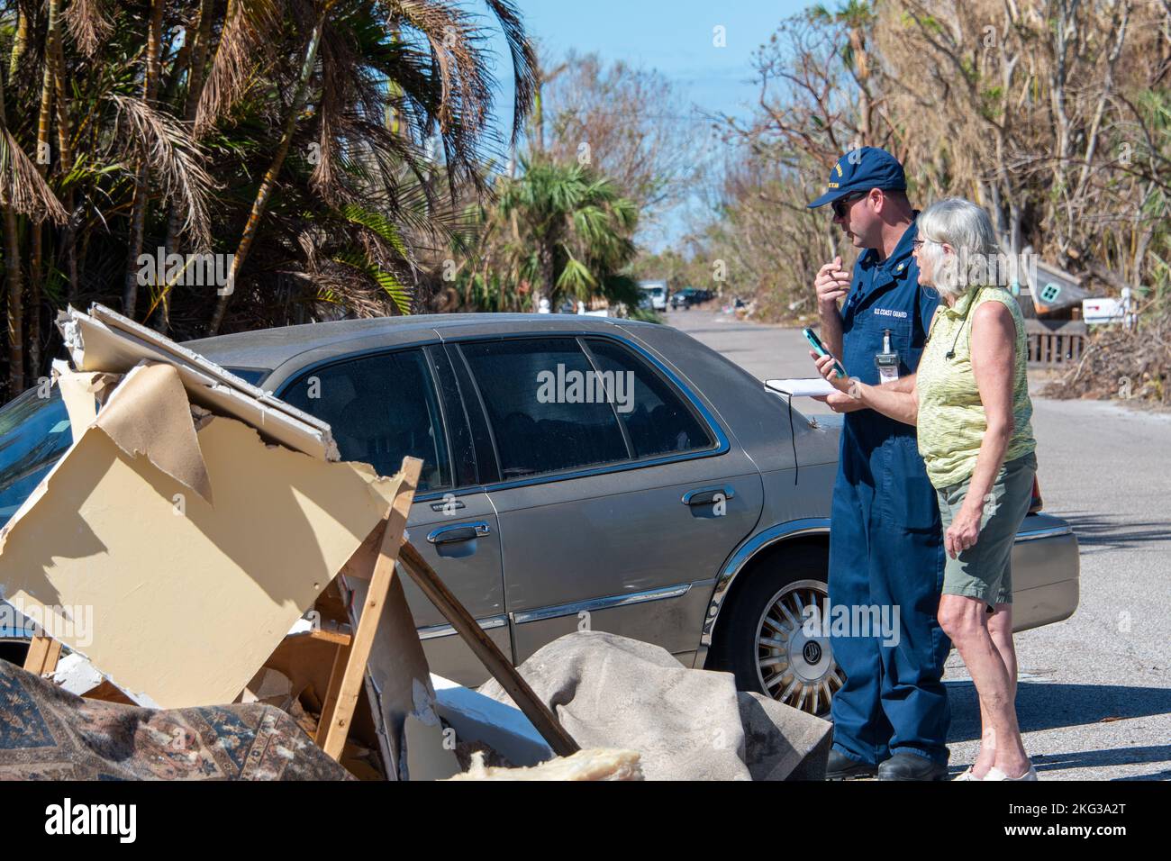 Coast Guard Petty Officer 1st Class Dustin Madden talks to a resident ...