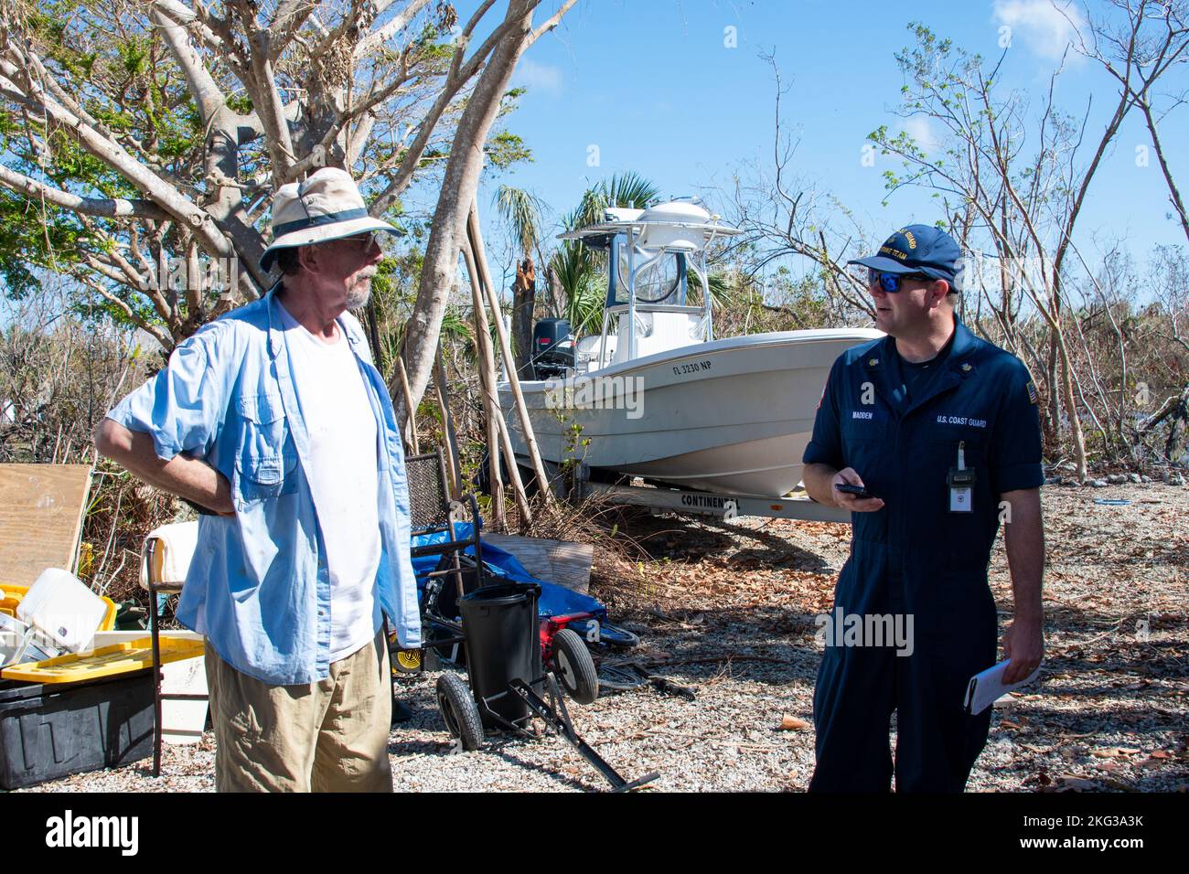 Coast Guard Petty Officer 1st Class Dustin Madden talks to a resident ...