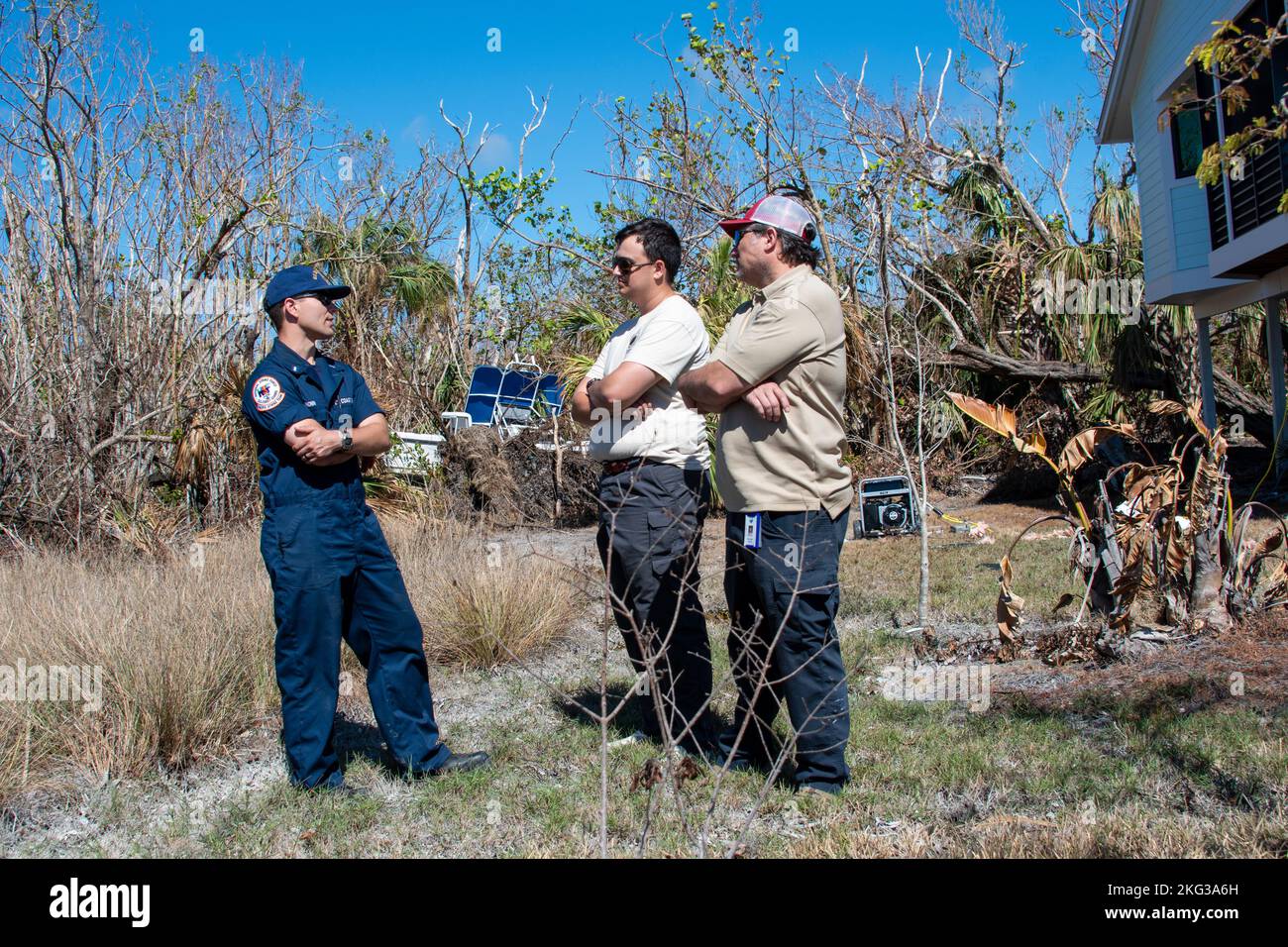 Coast Guard Lt. j.g. Trent Brown talks with Jon Belcher and Alexander ...