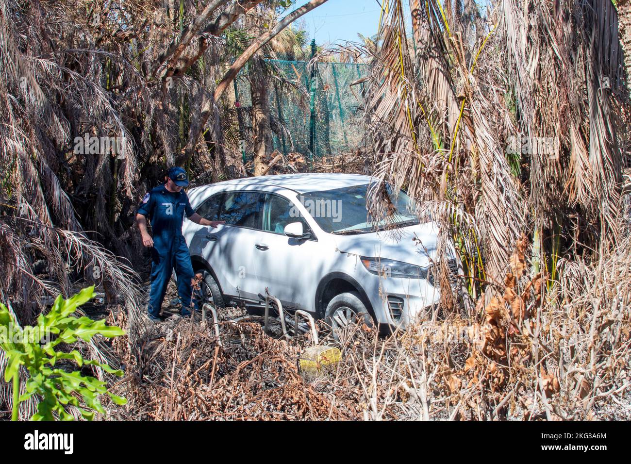 Coast Guard Petty Officer 1st Class Dustin Madden assesses a displaced ...
