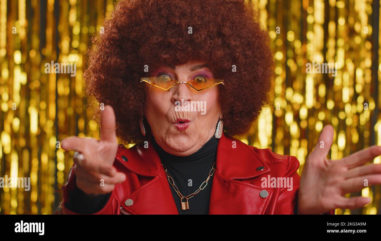 Oh my God, Wow. Excited amazed winner old woman raising hands in ...