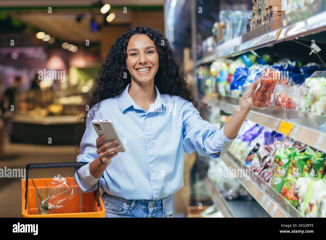 Portrait happy and smiling woman shopper in a supermarket Hispanic ...