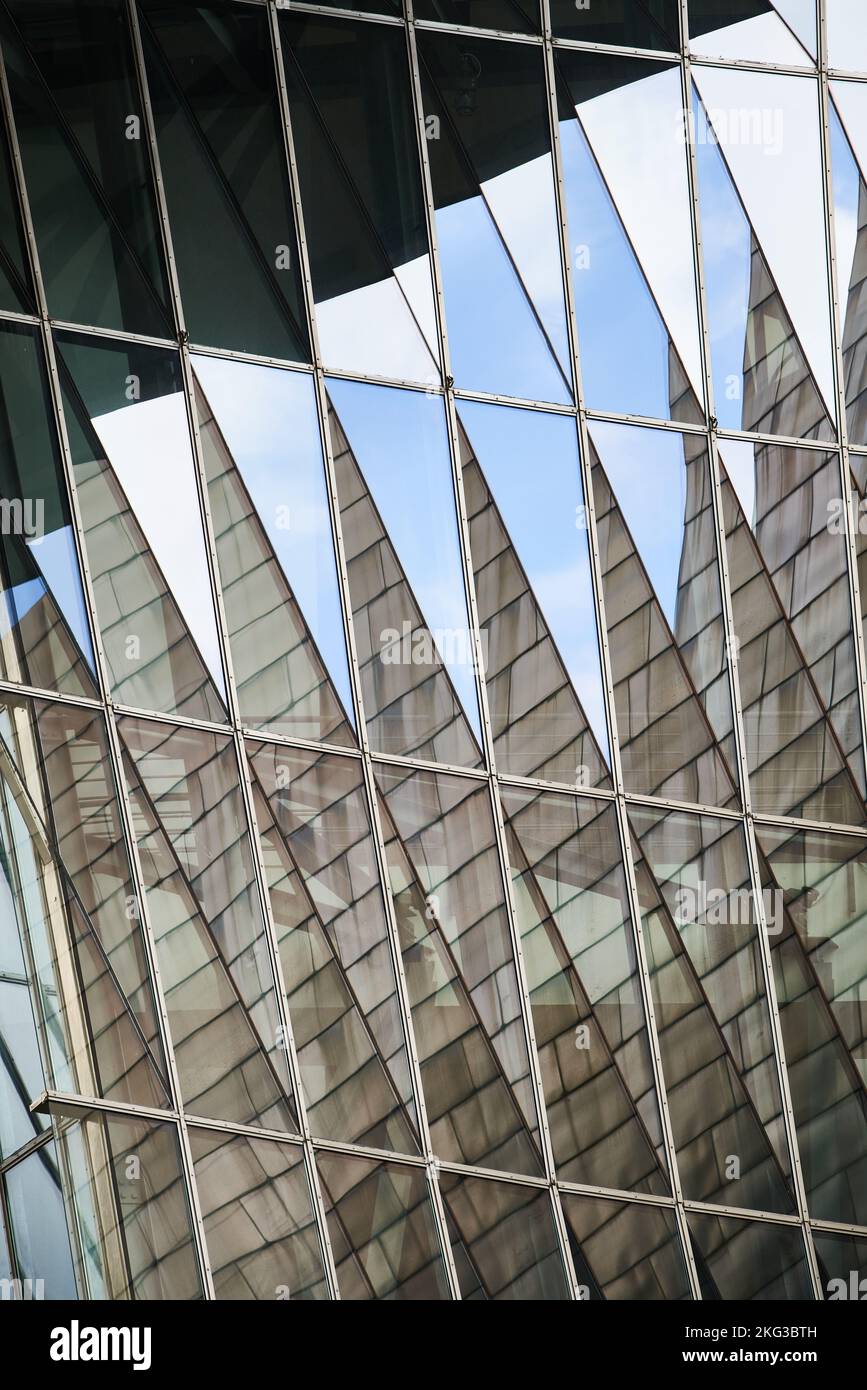 Detail of the modern facade of geometric shapes and reflections in the ...